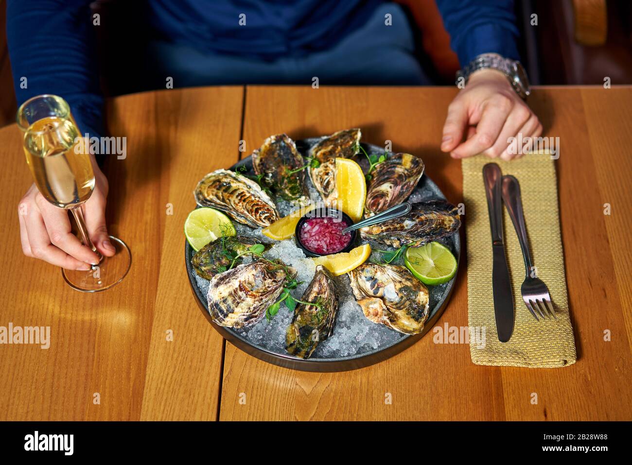 man eating oysters at the table Stock Photo - Alamy