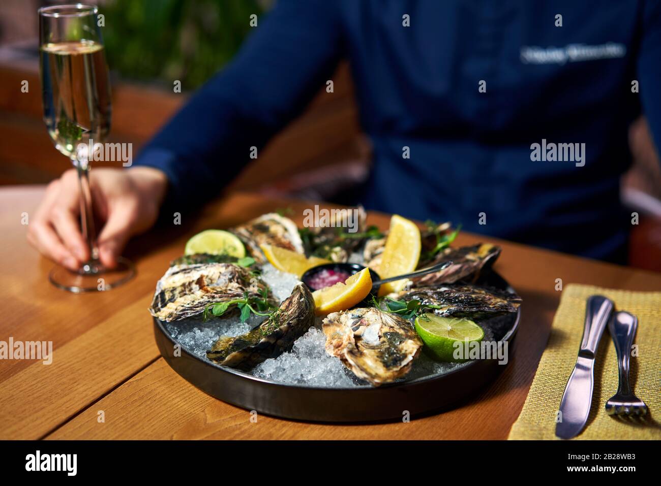 man eating oysters at the table Stock Photo - Alamy