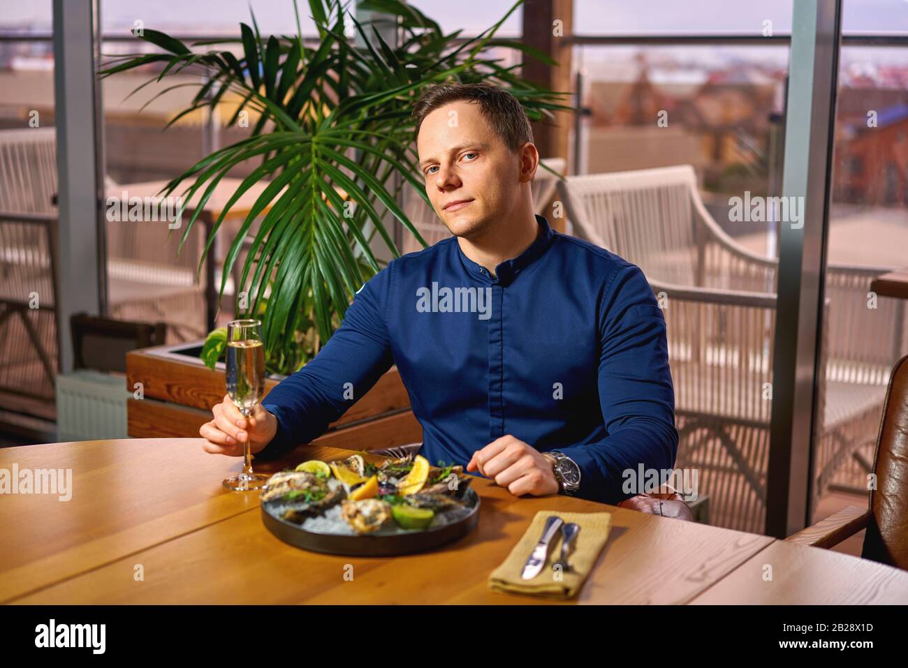 man eating oysters at the table Stock Photo - Alamy