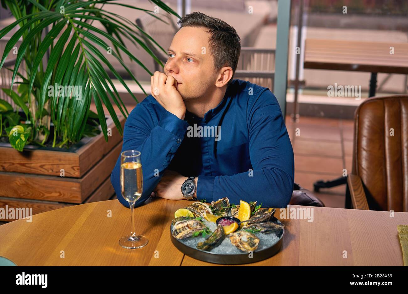 man eating oysters at the table Stock Photo - Alamy