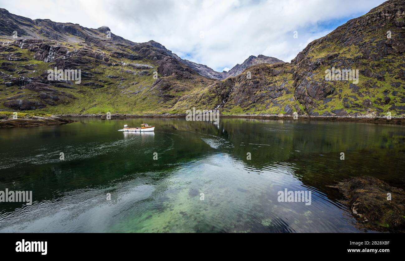 Beautiful scenic landscape of amazing Scotland nature with fishing boat ...