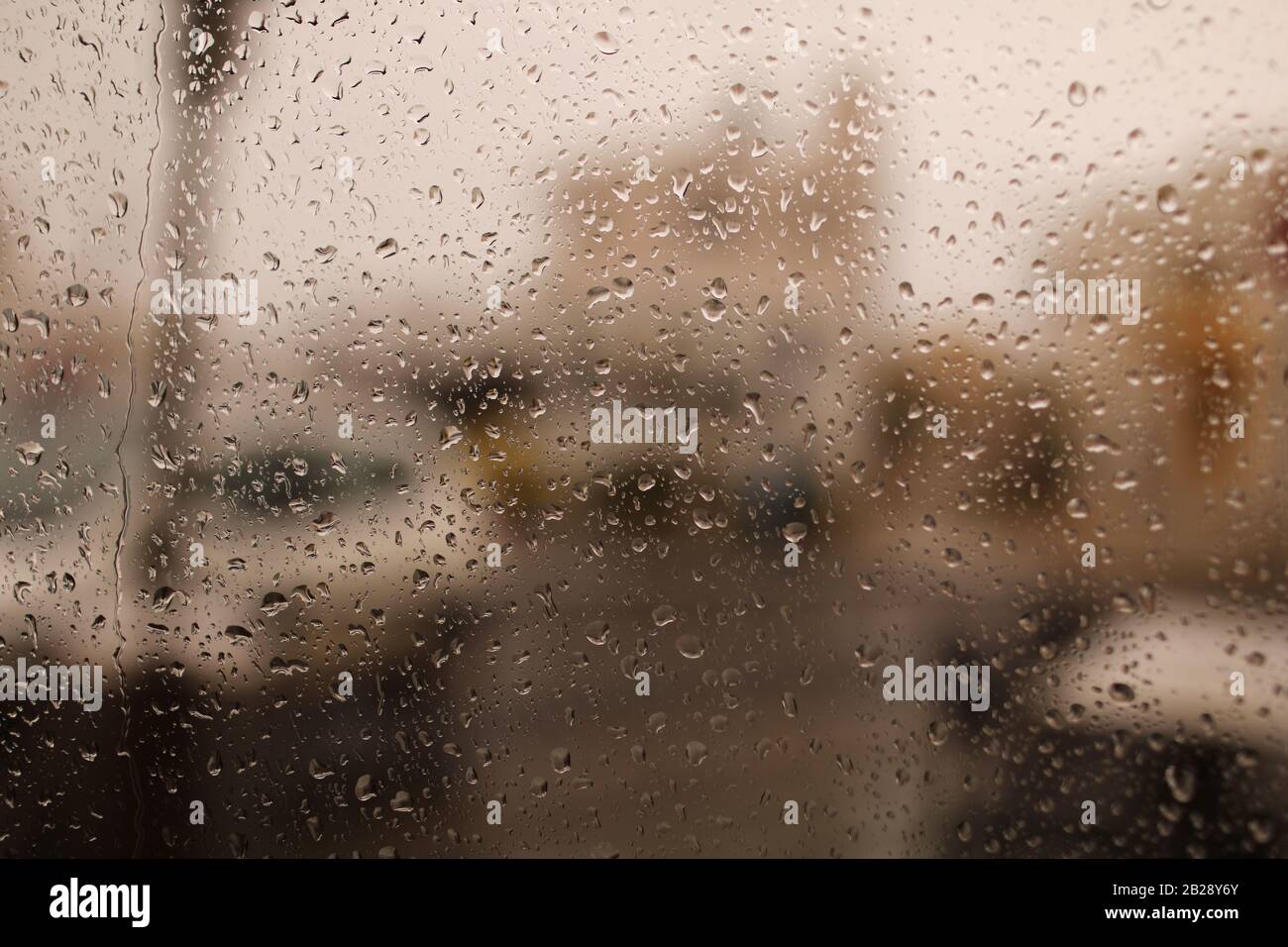 Raindrops on window. drops of water from the rain flow down the glass ...