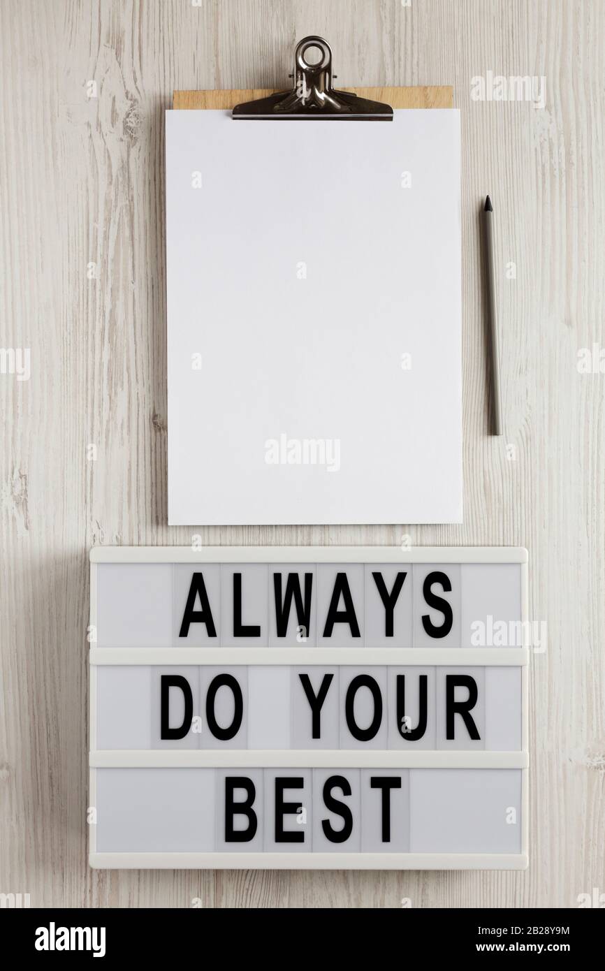'Always do your best' words on a lightbox, clipboard with blank sheet ...