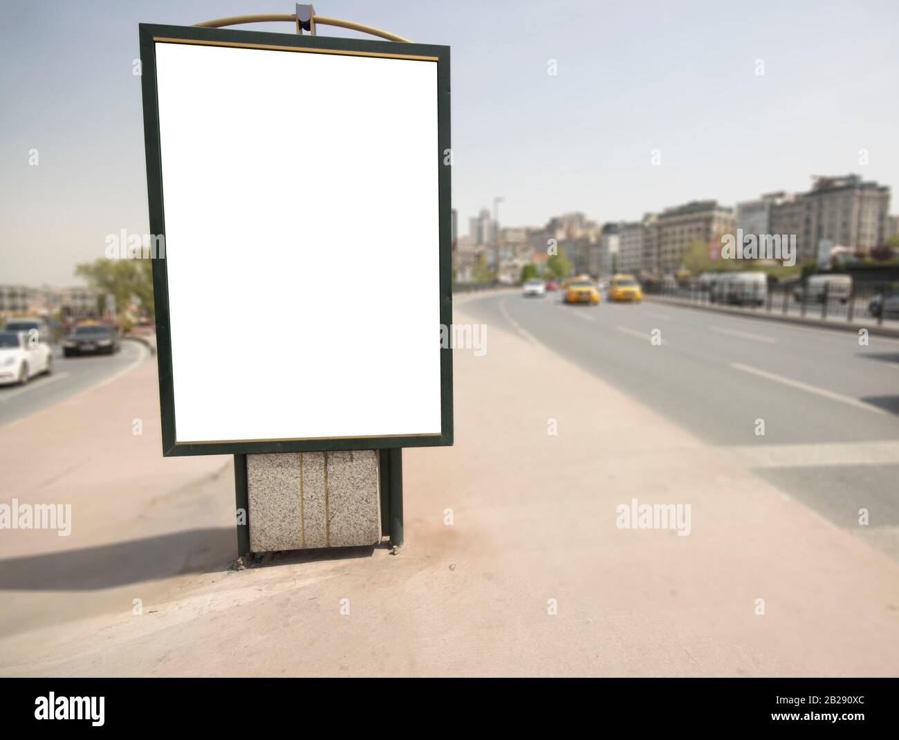 Rectangular blank white color billboard. It stands beside the road. I ...