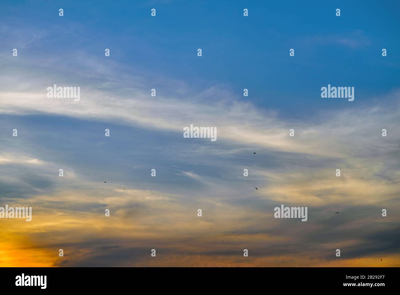 Multi colored clouds at sunset. The clouds lit by the setting sun Stock ...