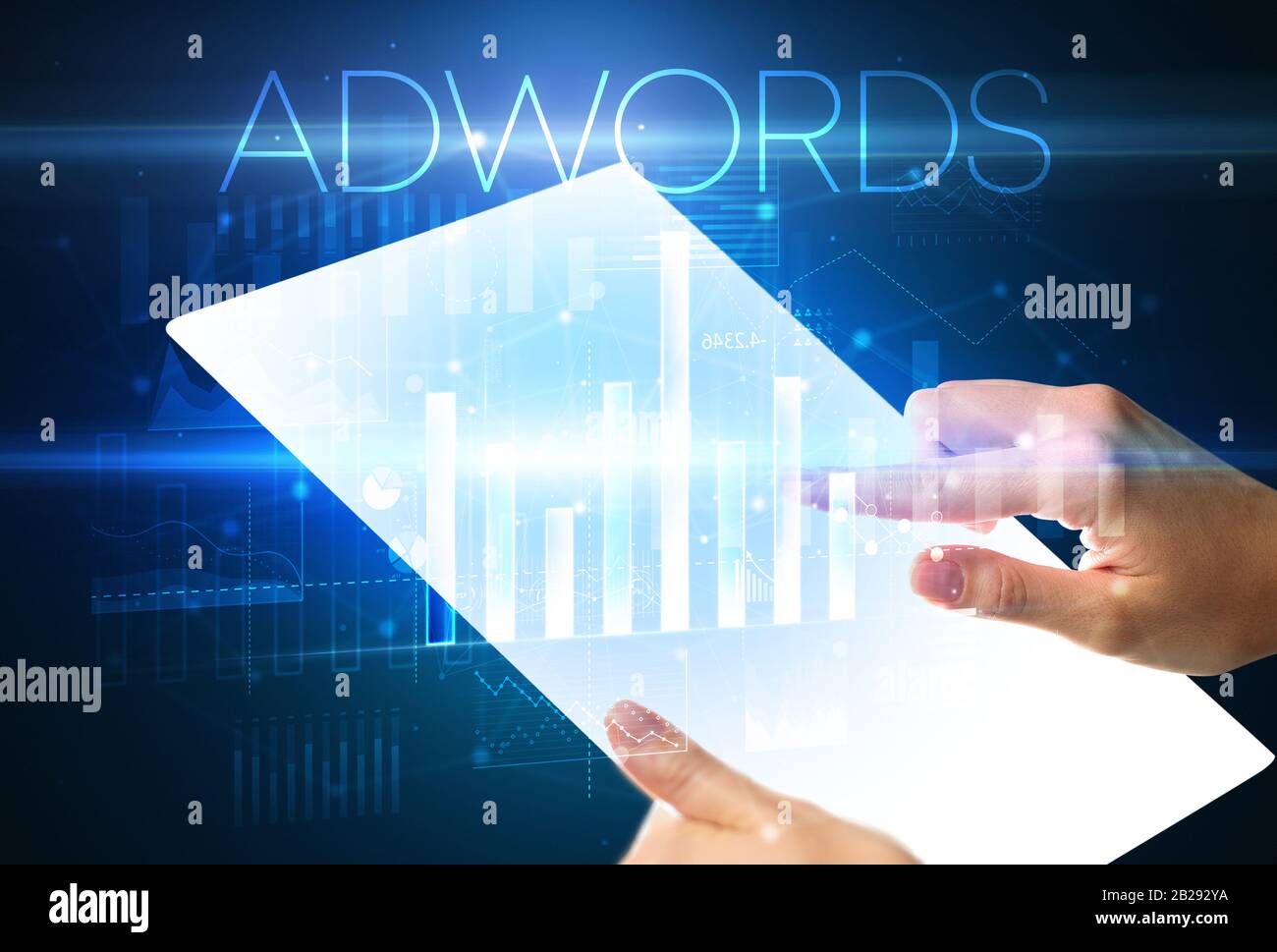 Hand holding futuristic tablet with ADWORDS inscription above, modern ...