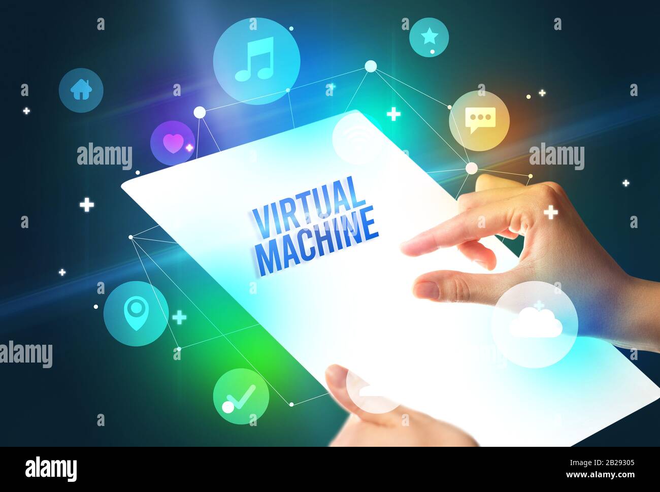 Holding futuristic tablet with VIRTUAL MACHINE inscription, new ...