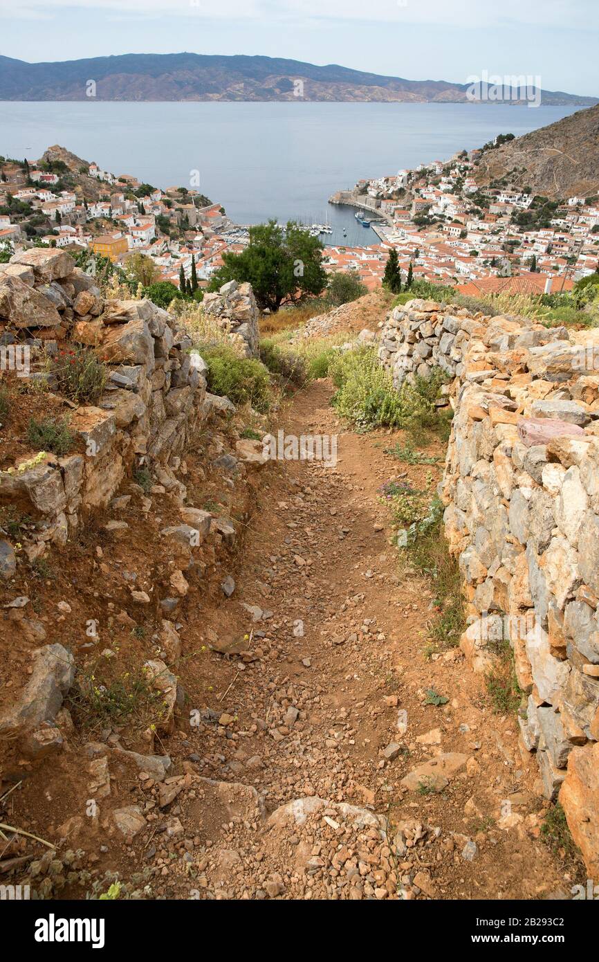 Rocky dirt path and stone walls above the town of Hydra port and harbor ...