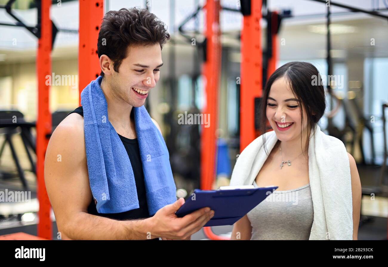 Woman and personal trainer talking hi-res stock photography and images ...