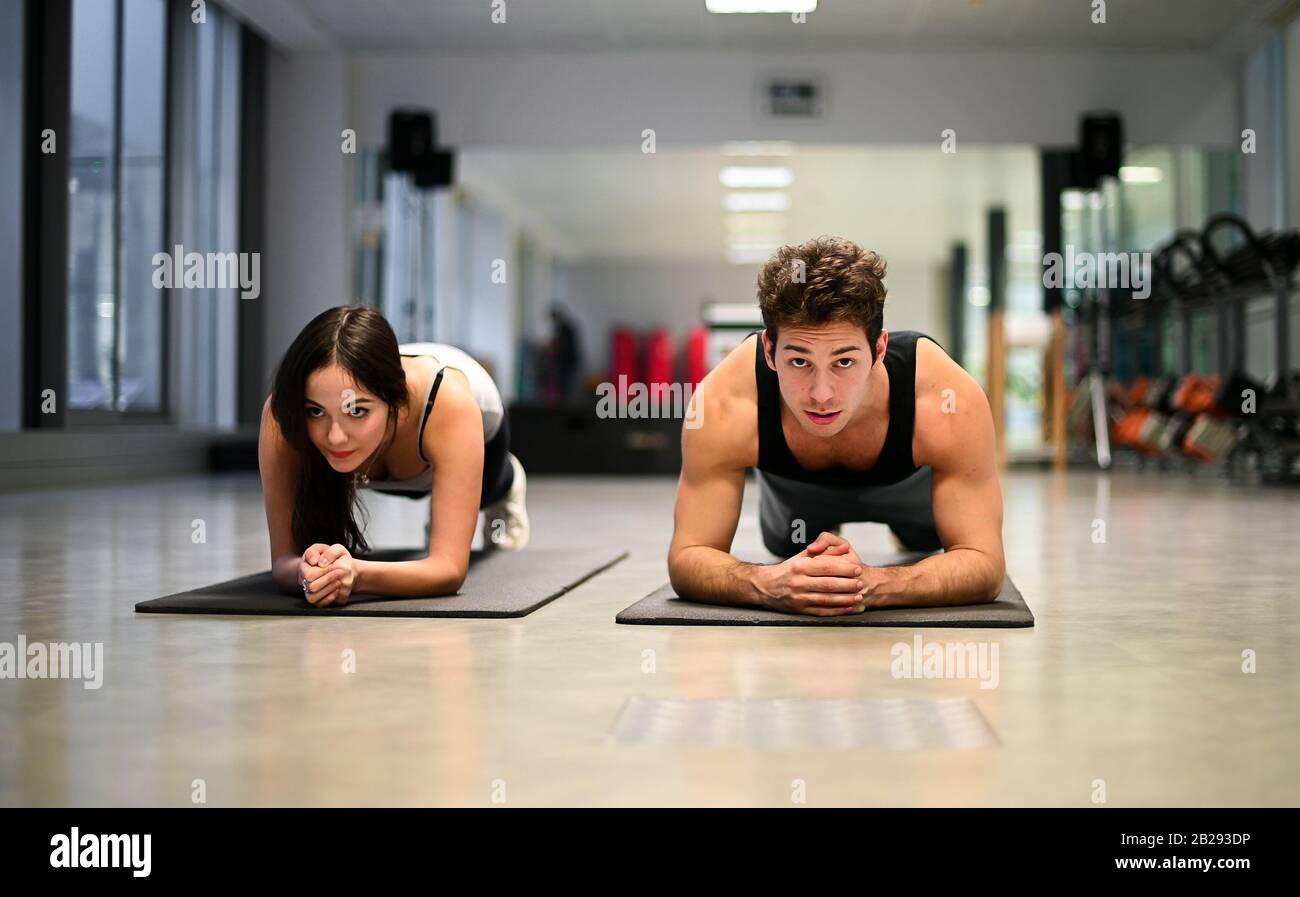 Two atheletes doing push ups in a gym Stock Photo - Alamy