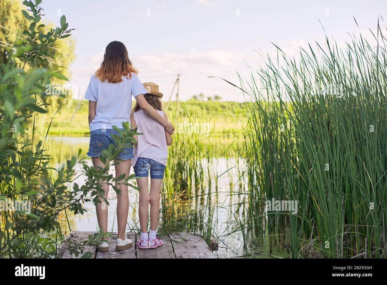 Two children playing near pond hi-res stock photography and images - Alamy