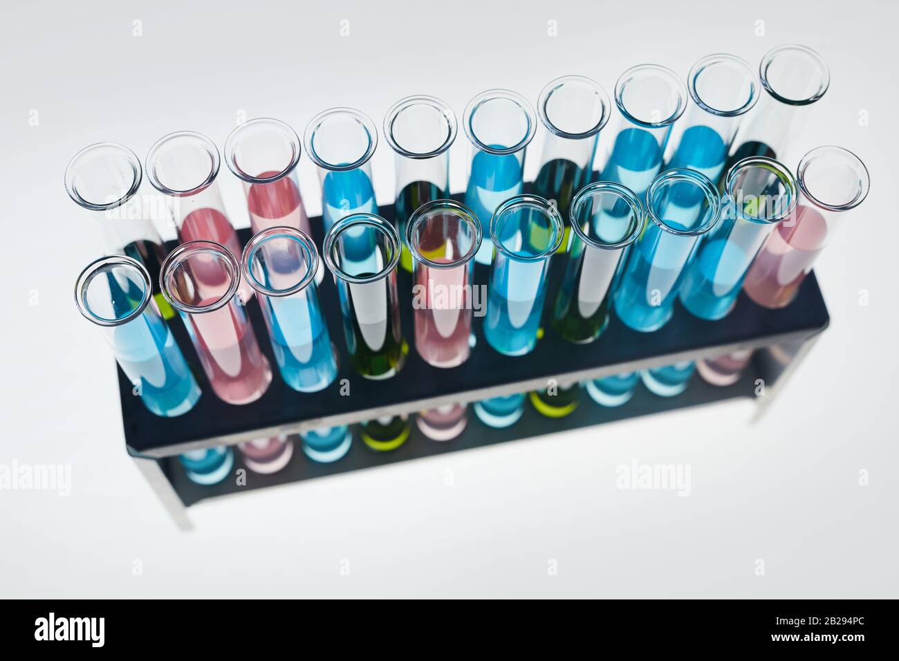 Above view background of test tubes with colored liquid on white table ...