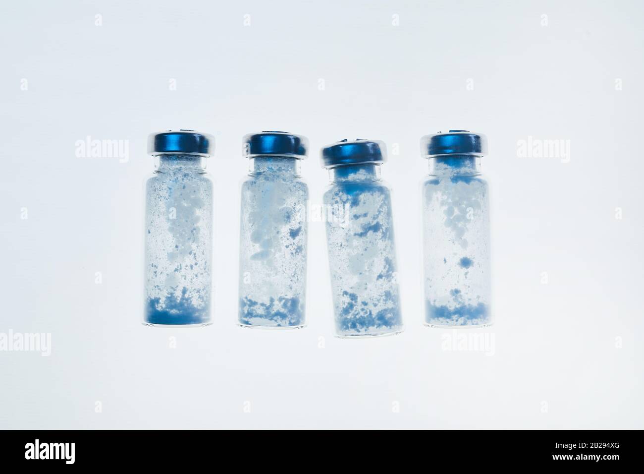 Top view background image of glass vials in row on white table in ...