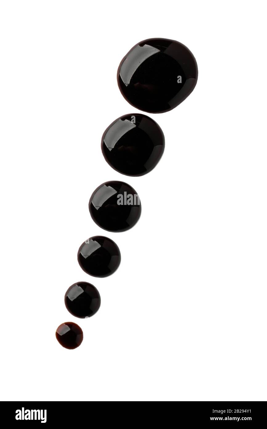 Chocolate syrup drops isolated on white background Stock Photo - Alamy