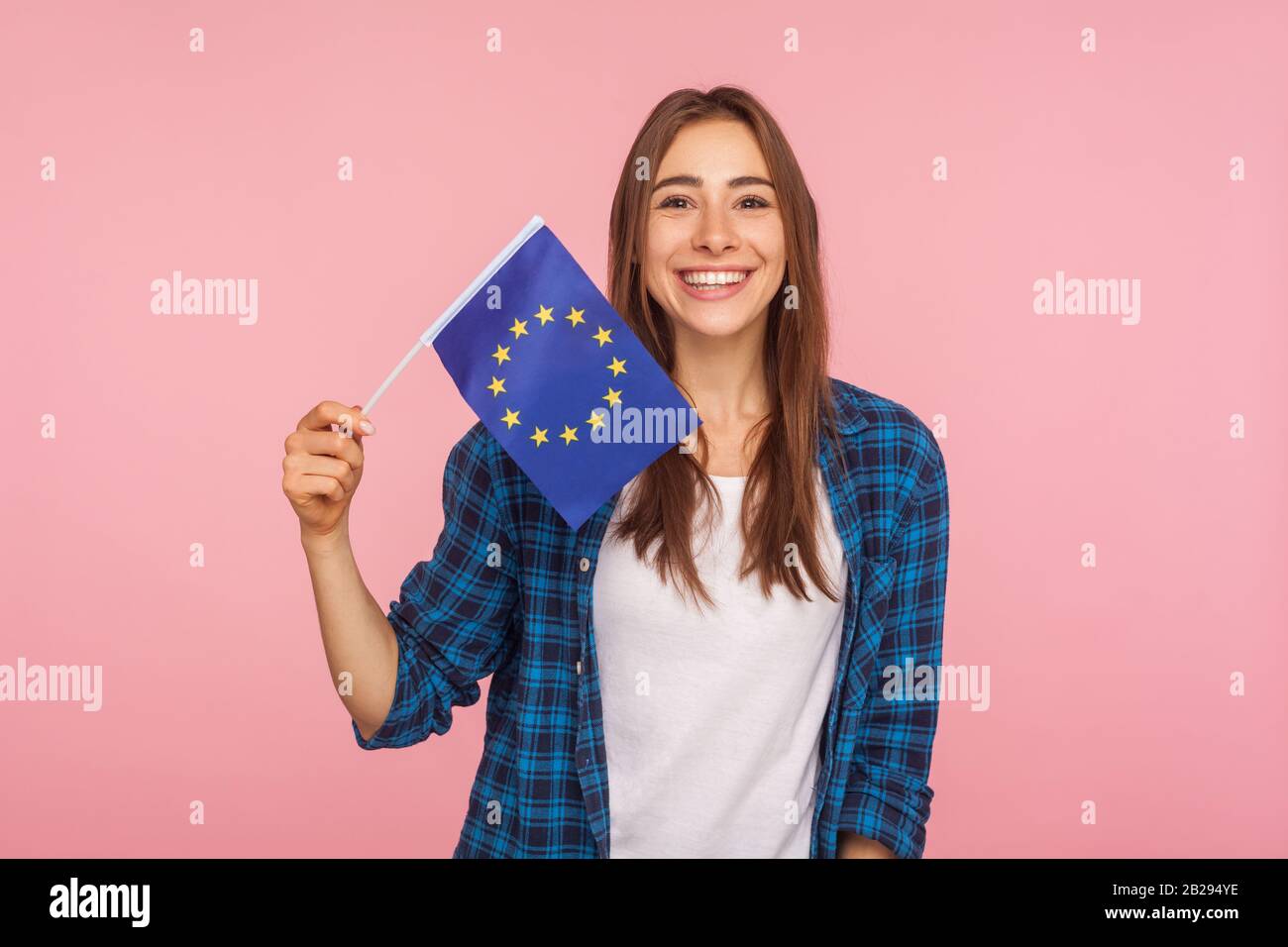 Portrait of friendly pretty woman in checkered shirt smiling broadly ...