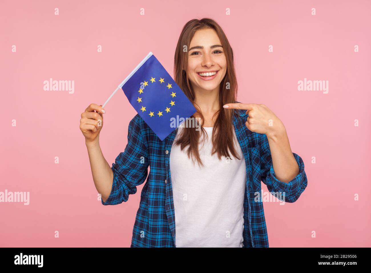 Portrait of positive friendly woman in checkered shirt smiling broadly ...