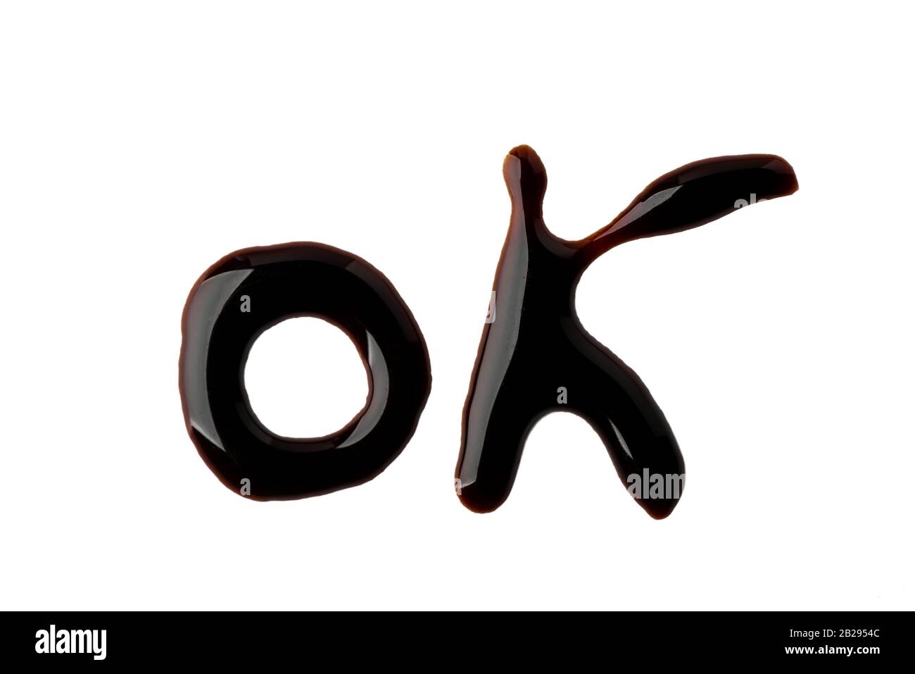 OK lettering made with chocolate syrup and isolated on white background ...