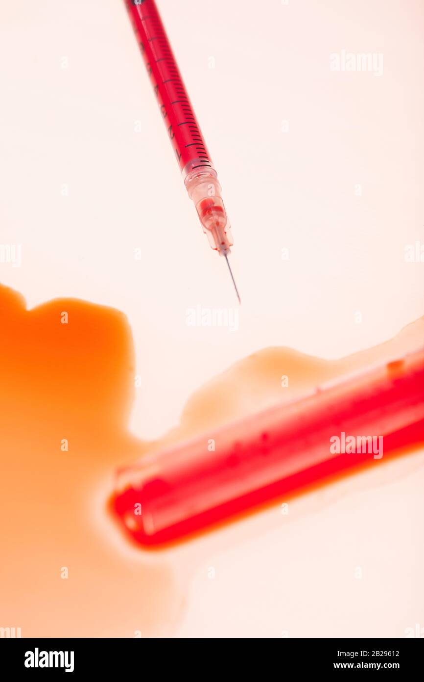 Above view background of syringe and blood spilling around test tube ...