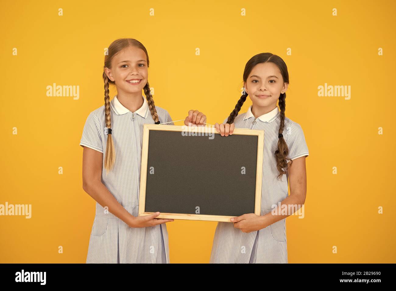 True information. Little girls hold writing surface yellow background ...
