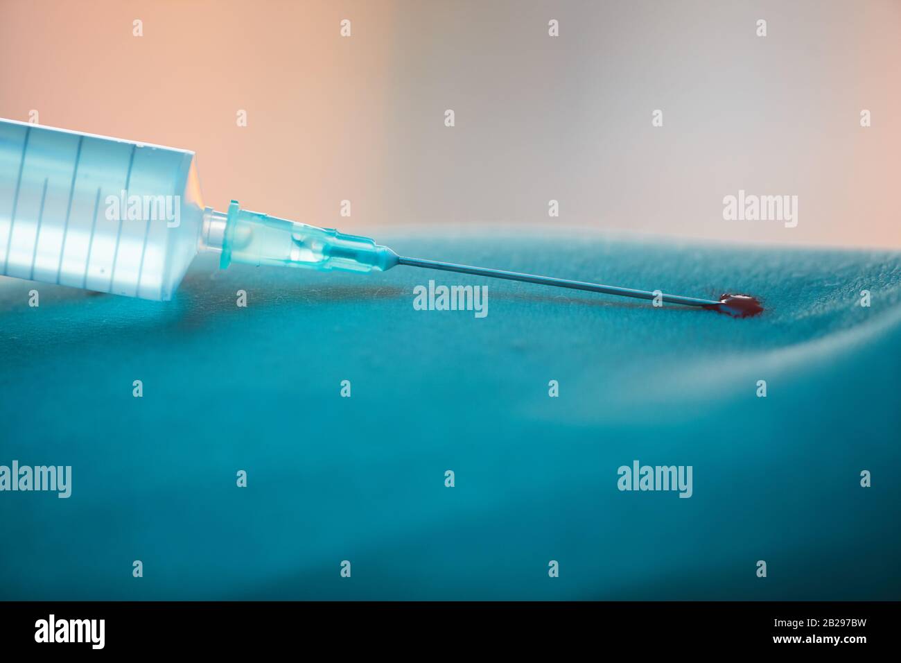 Extreme close up of medic inserting syringe into vein on male arm while ...