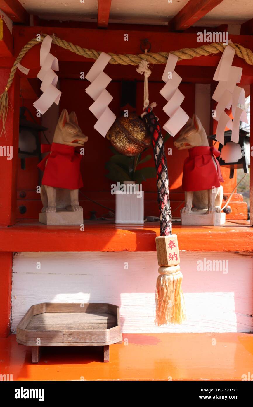 Shinto altar dedicated to Japanese rice deity Inari fox Stock Photo - Alamy