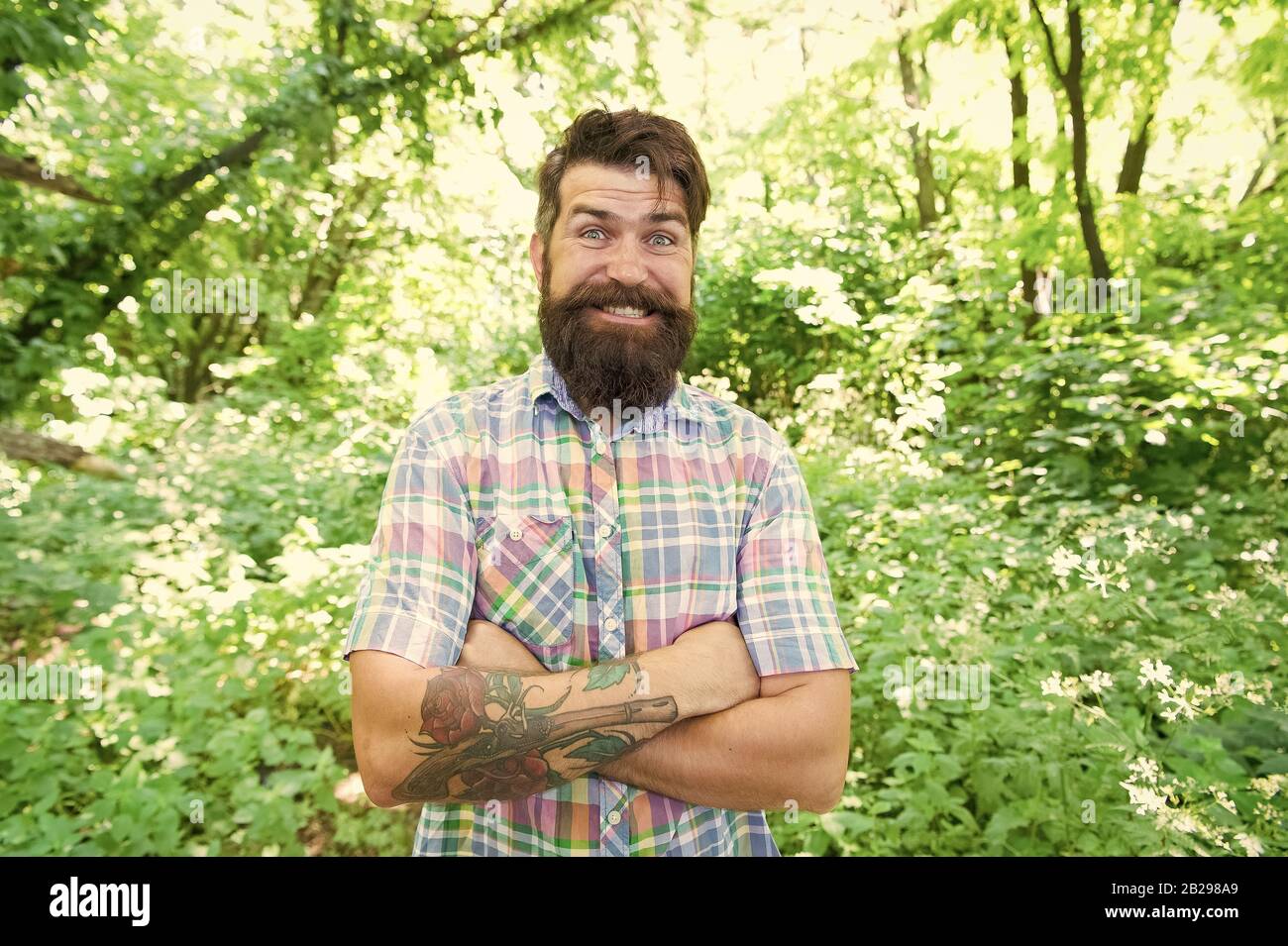 Emotional nature lover. Man bearded hipster green trees background. Guy ...