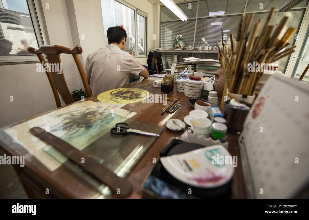 BEIJING, СHINA - JUNE 03: Chinese craftsman paints a large porcelain ...