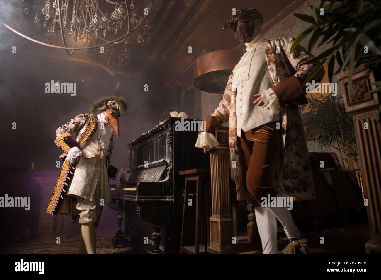 Actors in Steam punk masks and antique costumes indoor Stock Photo - Alamy
