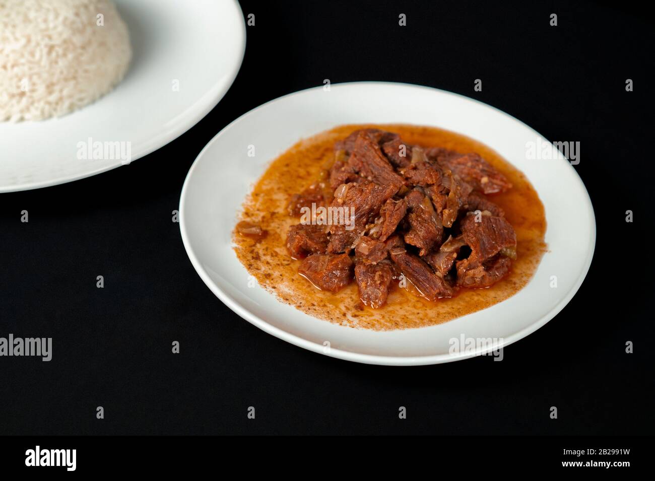Greek dish Stifado, made with lamb and served with Greek salad. Can ...