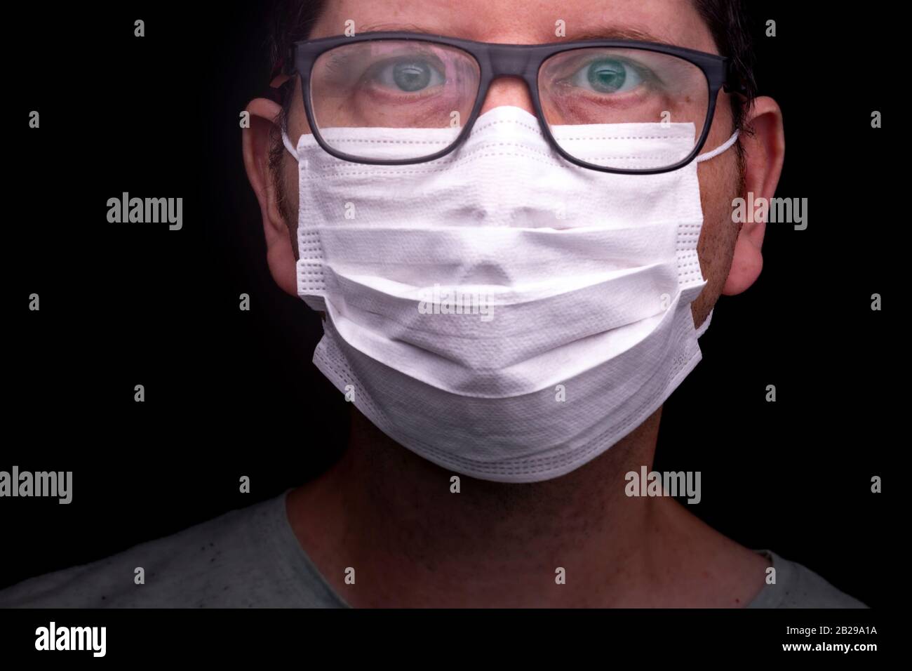 Caucasian male with blue eyes and glasses looking straight into the ...