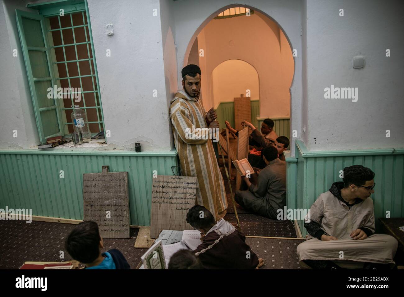 Tripoli, Libya. 1st Mar, 2020. Teacher Sheikh Sa'ad Muftah (C) is seen ...