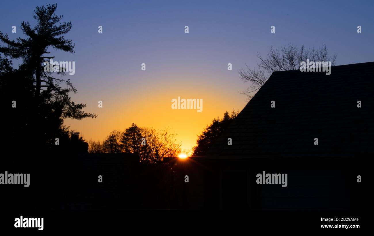 A Light Orange and Deep Blue Sunset With a Circular Pattern around the ...