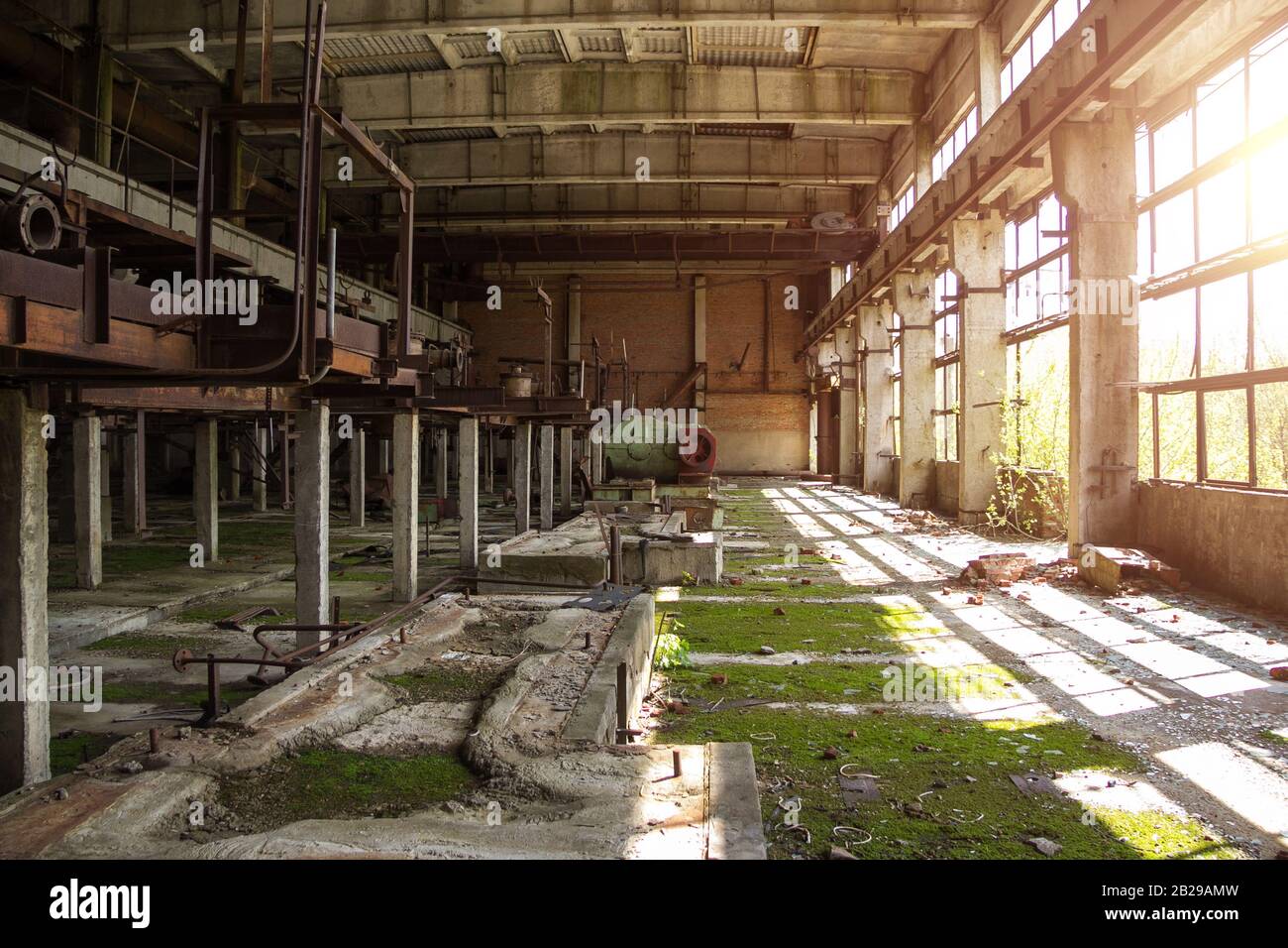 Old abandoned factory with rusty remains of industrial machinery in ...