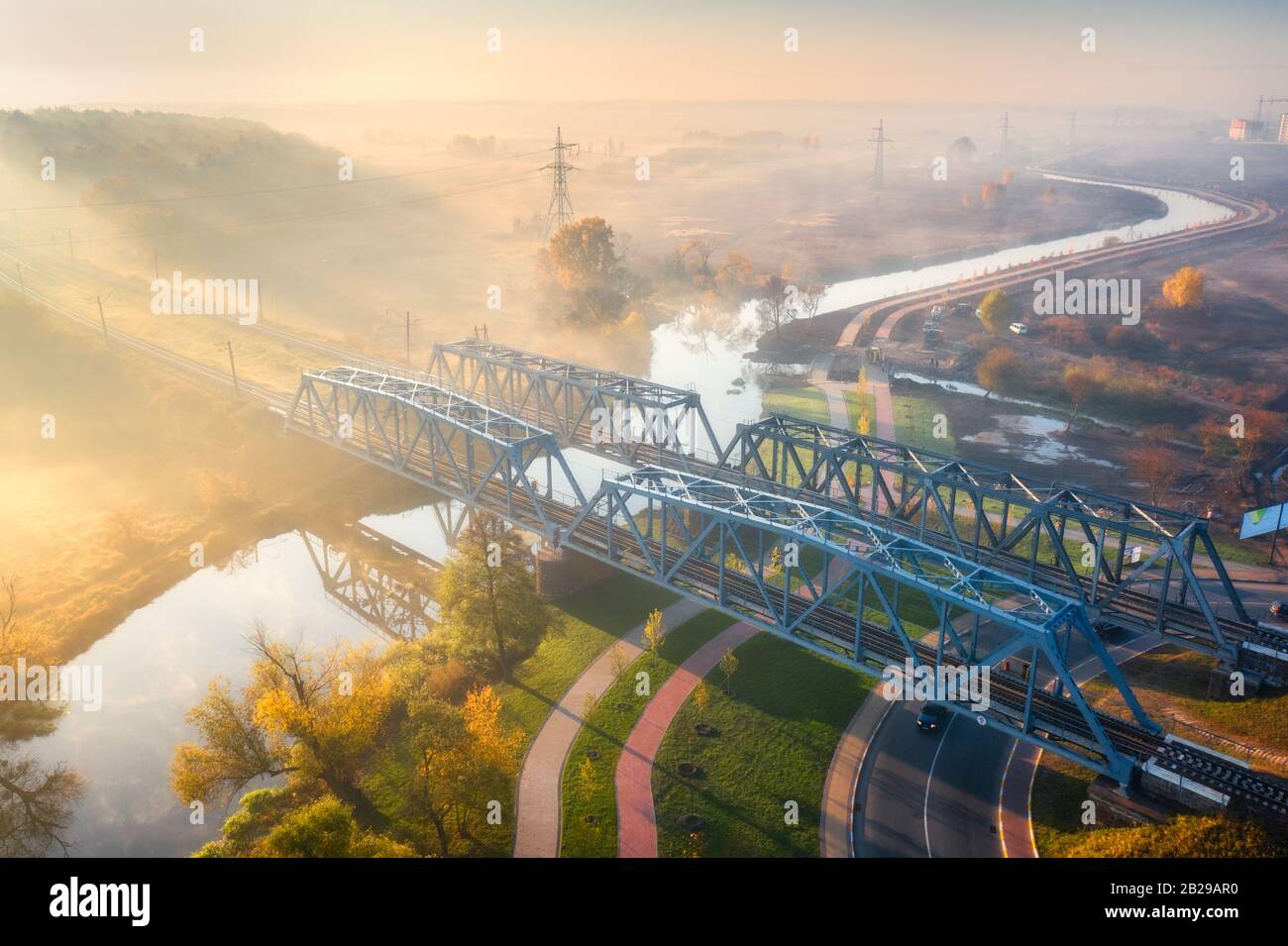 Aerial view of railroad bridge and river in fog at sunrise Stock Photo ...