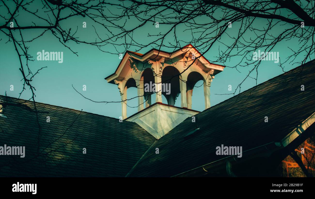 A Small Tower on the Roof of a Building With Trees Surrounding the ...