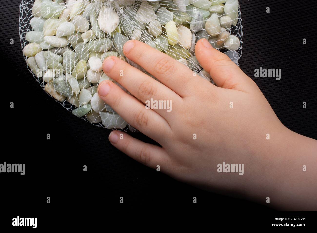Handful of clean pebbles, gravels in hands Stock Photo - Alamy