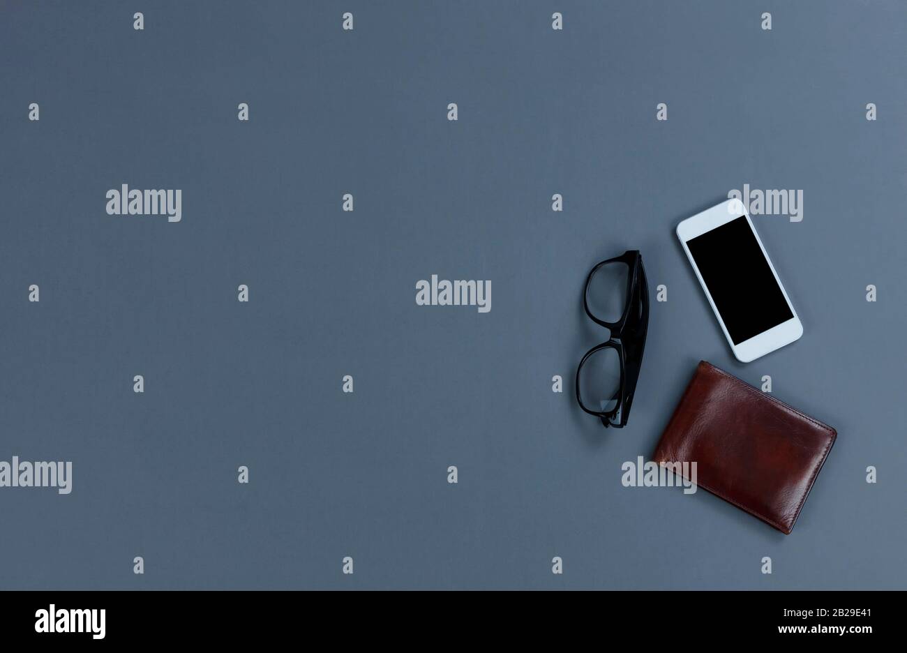 Office desktop with wallet, cell phone and reading glasses Stock Photo ...