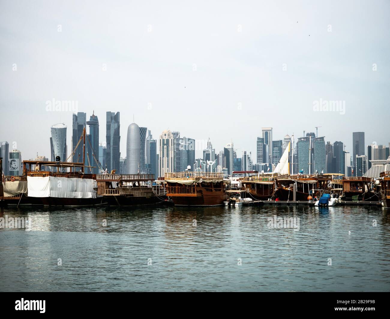 Ships in Dhow Harbour in front of Doha skyline in Qatar Stock Photo - Alamy