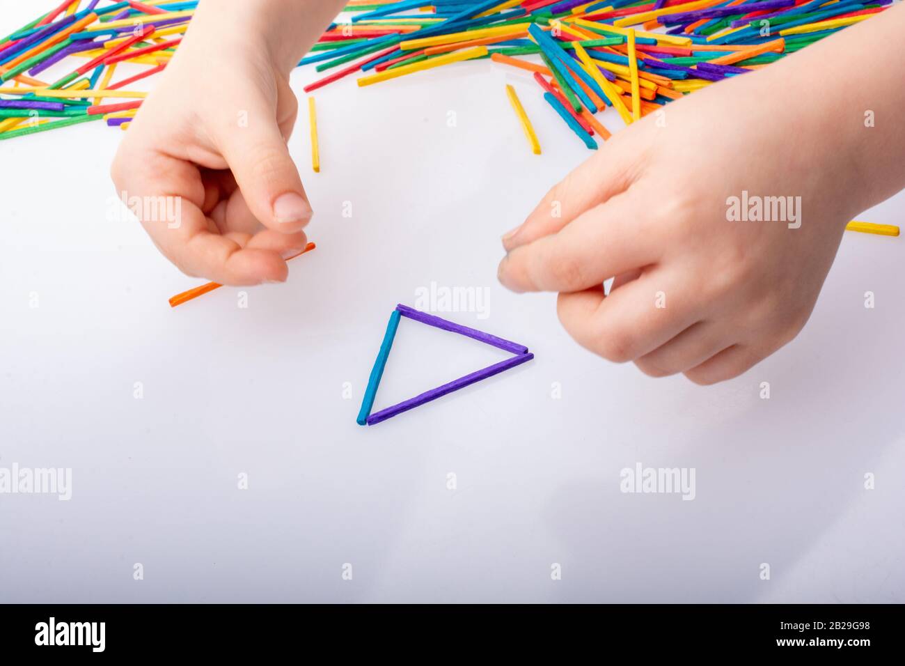 Kid making triangle shape on as creative concept Stock Photo - Alamy