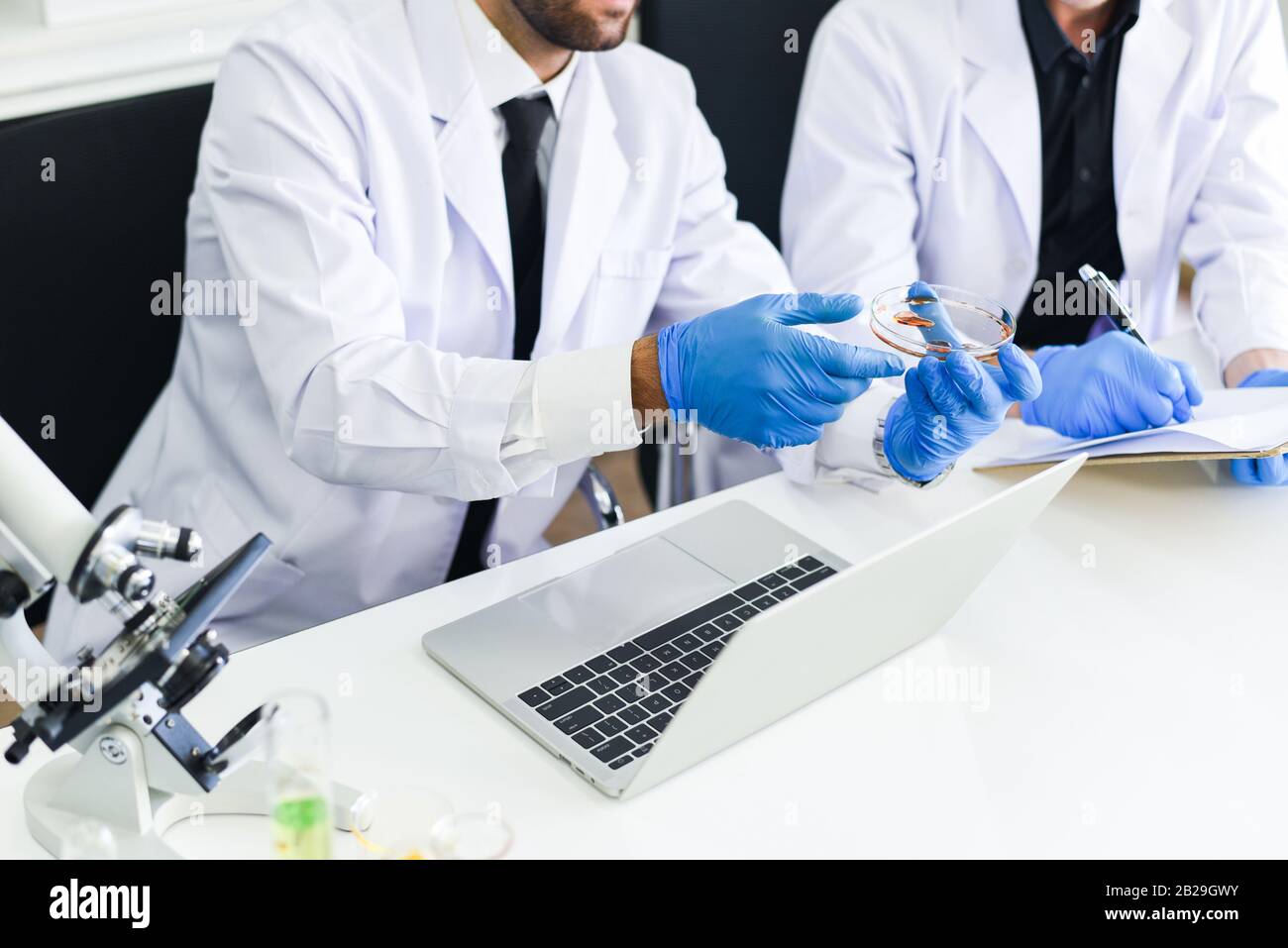 Doctor doing research using microscope hi-res stock photography and ...