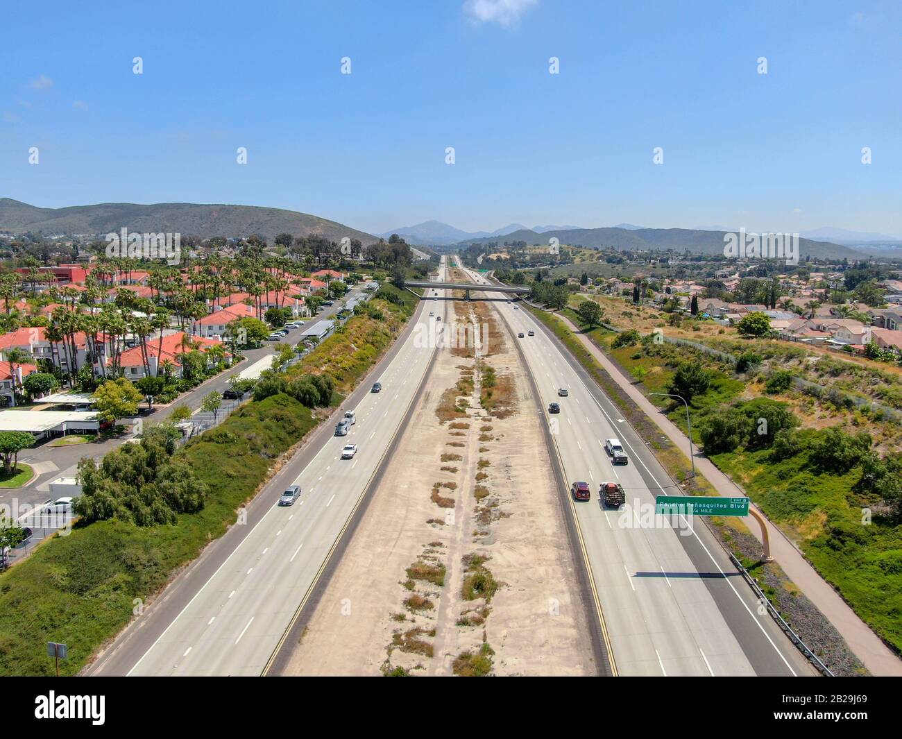 Aerial view of highway surrounded by villa in suburb. Intersection city ...