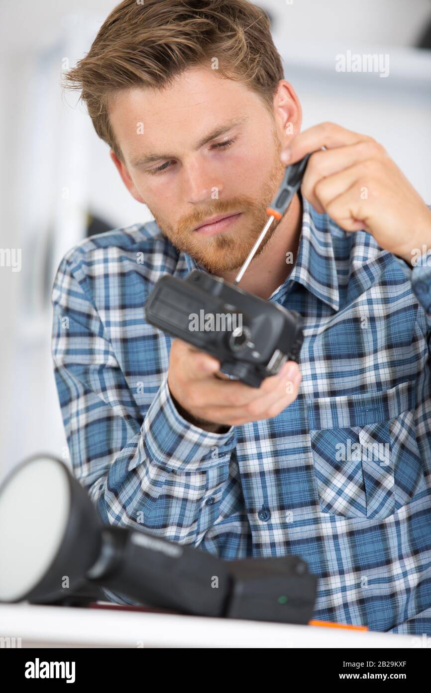 man disassemble a camera Stock Photo - Alamy
