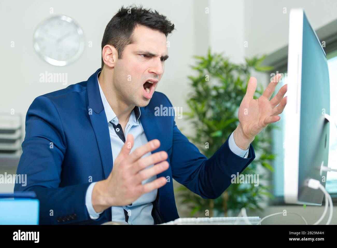 angry man at a computer screen Stock Photo - Alamy