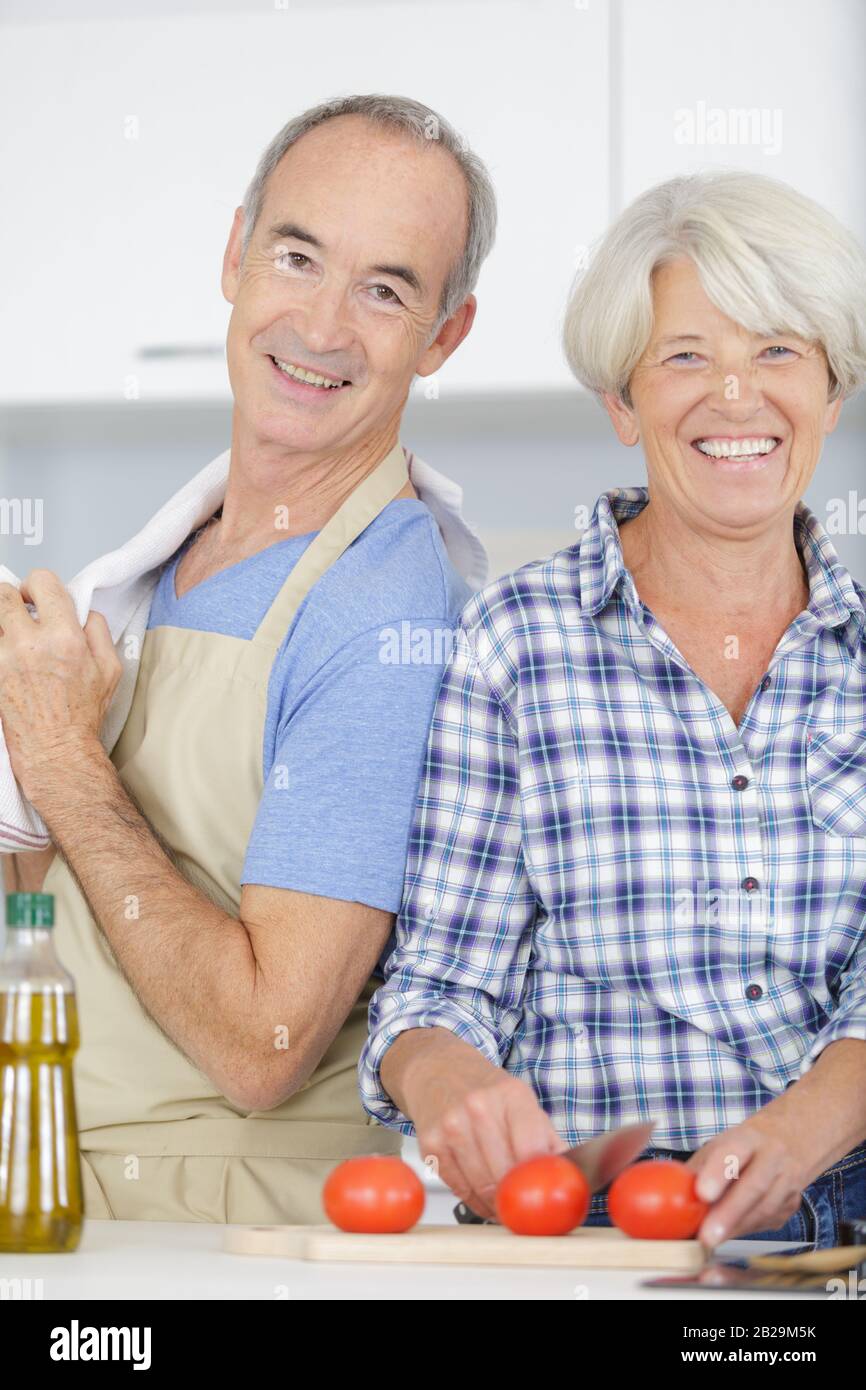 Senior woman chopping tomatoes hi-res stock photography and images - Alamy