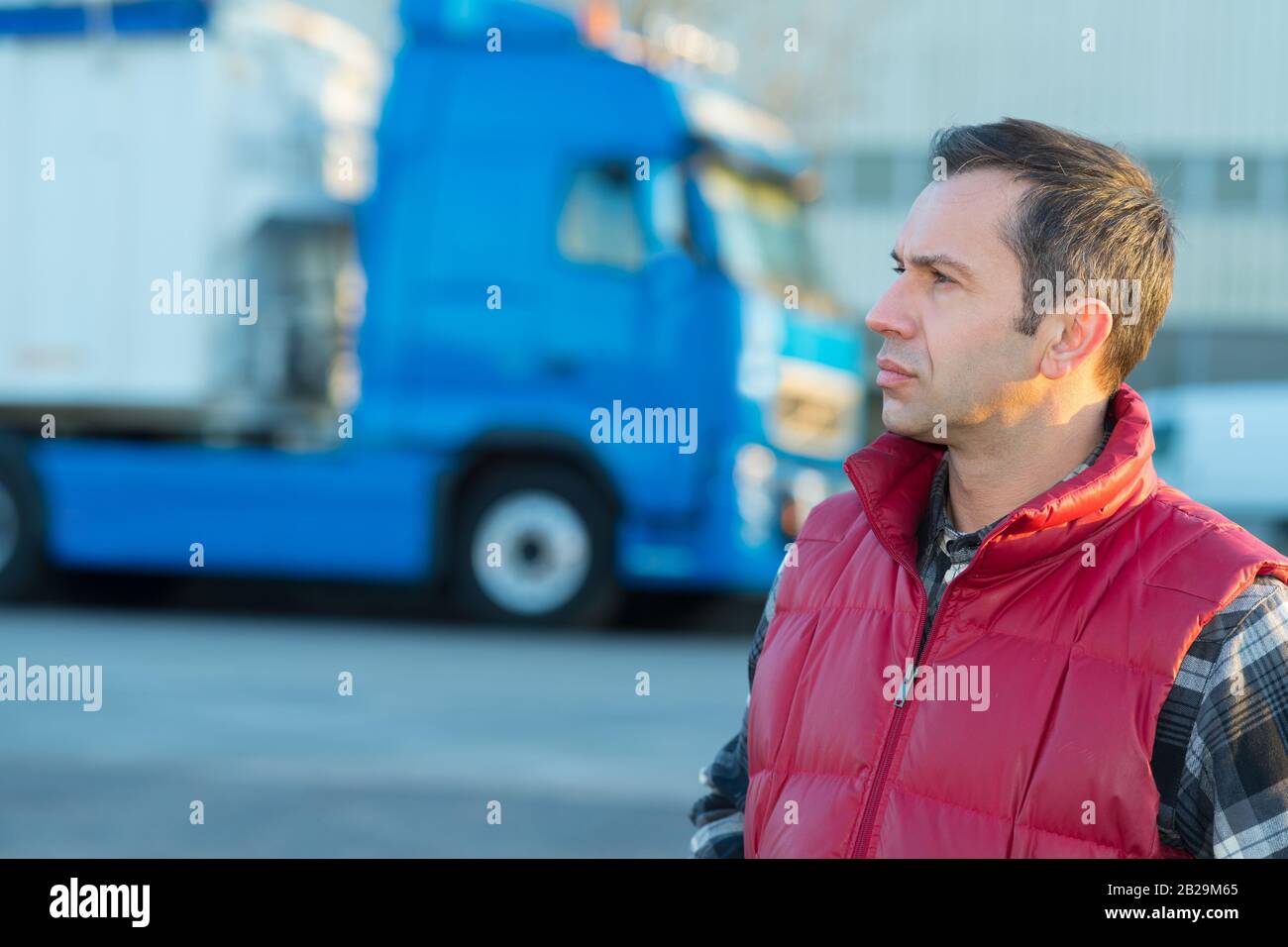 construction worker at the back of a lorry Stock Photo - Alamy