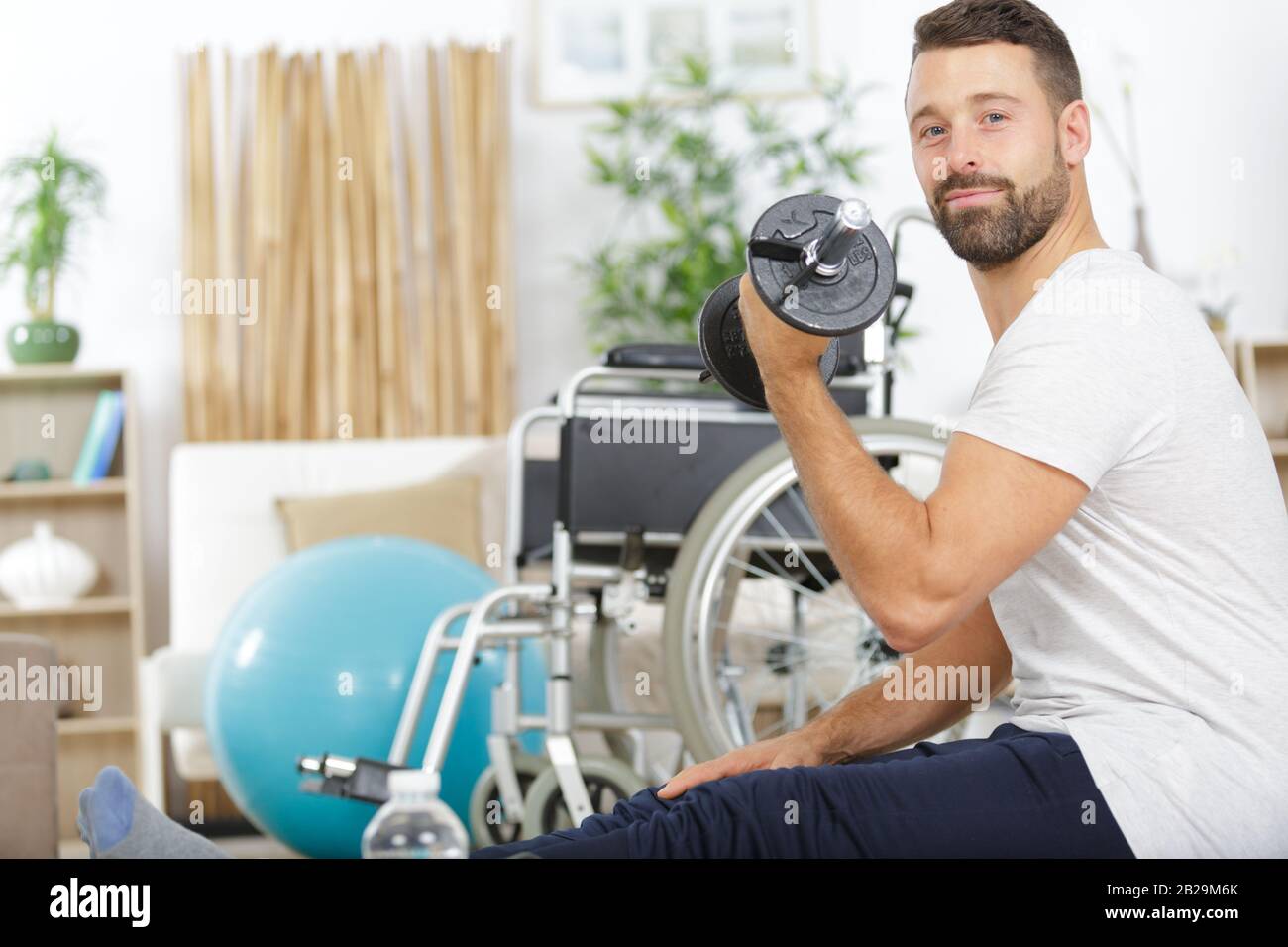 young handsome disabled paraplegic man in wheelchair doing ...