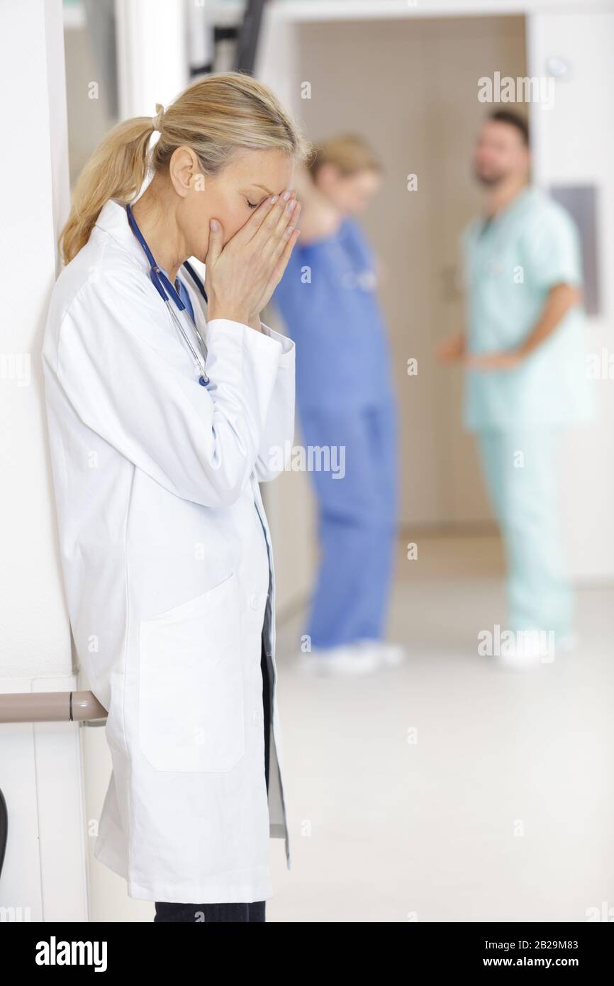 distressed female doctor in hospital corridor Stock Photo - Alamy