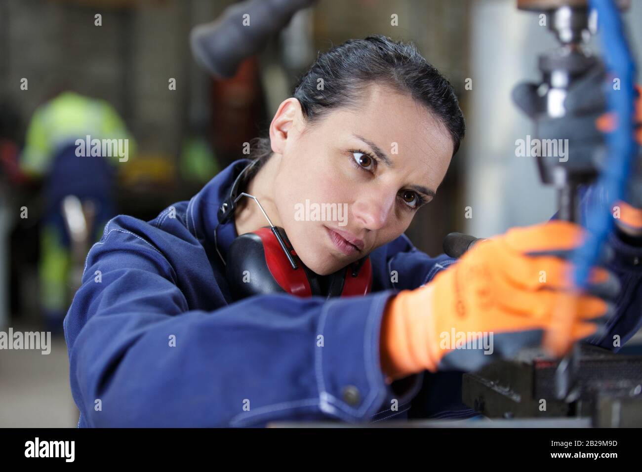 a concentrated female industrial worker Stock Photo - Alamy