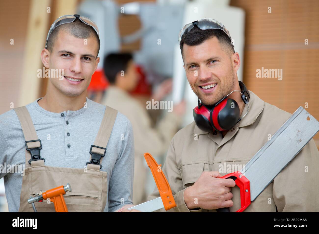 two of carpenters posing to the camera Stock Photo - Alamy