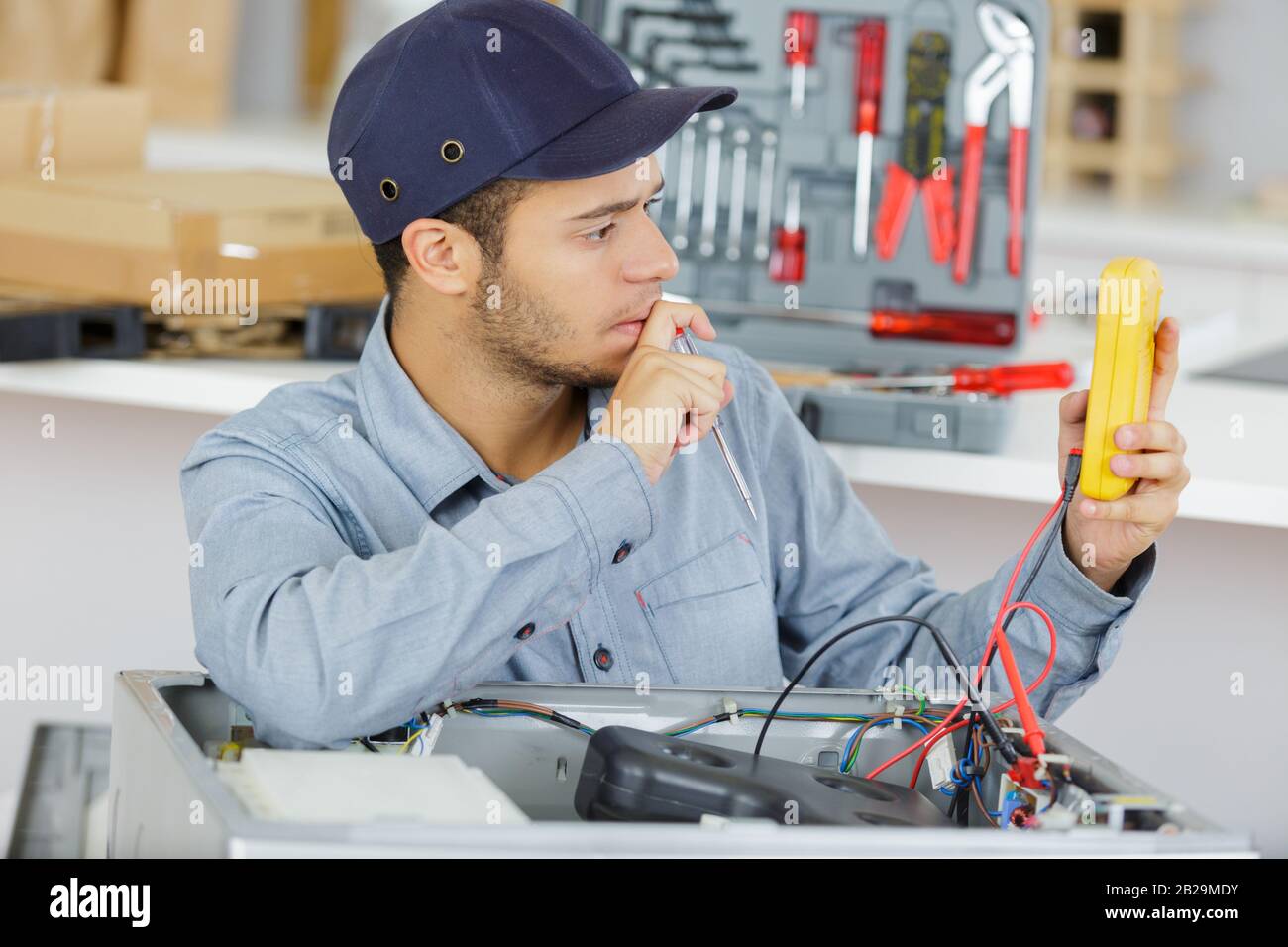 an electrician repairing a machine Stock Photo - Alamy